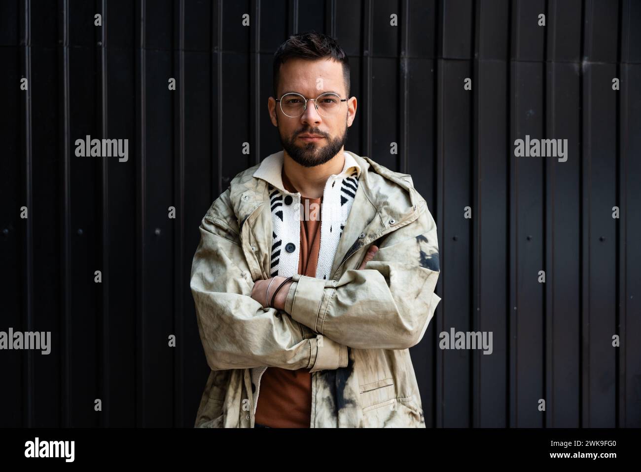 Young fashionable angry frustrated man standing alone outdoor, looking ...