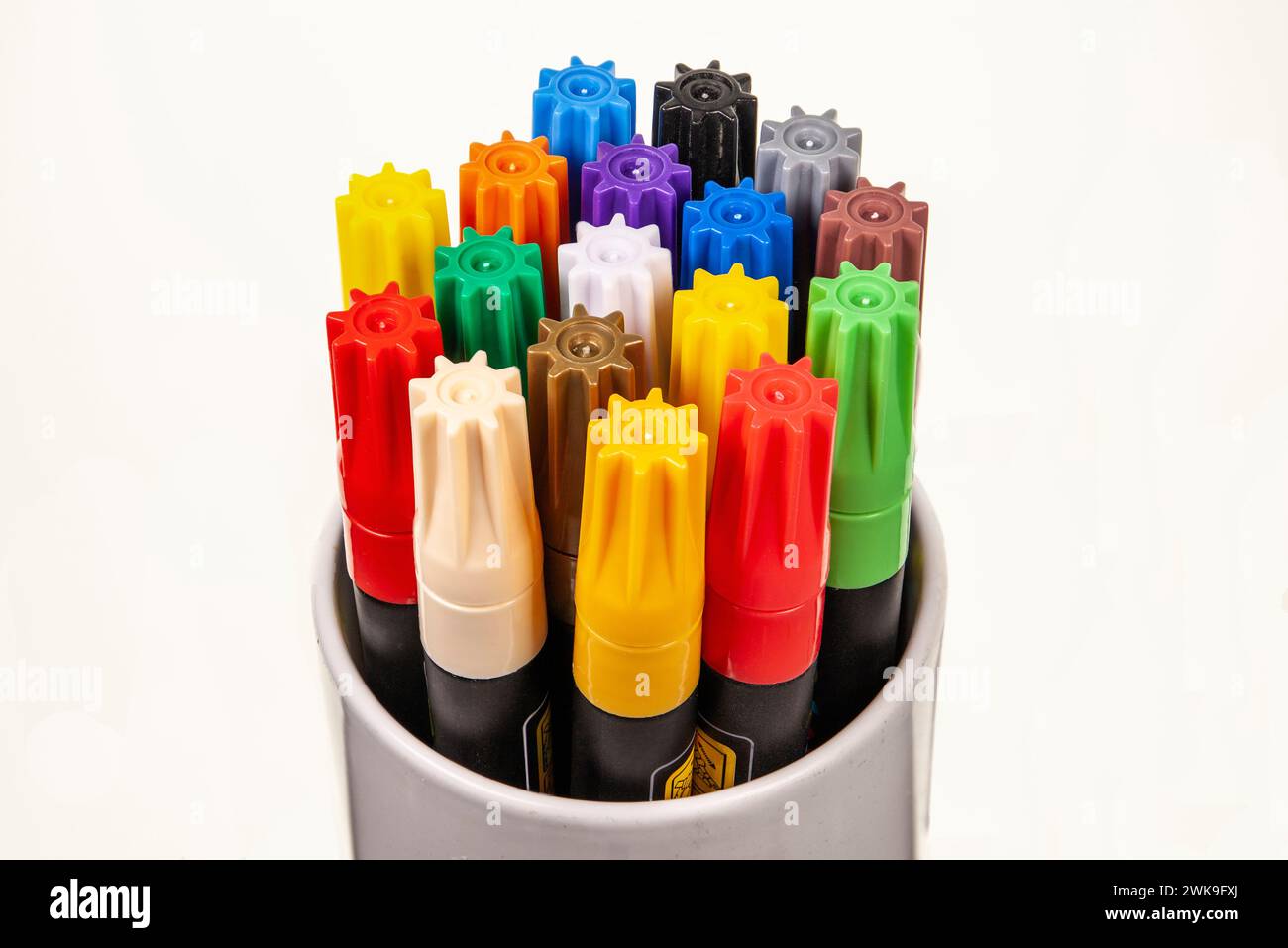 Horizontal group of assorted colored permanent markers on white ...