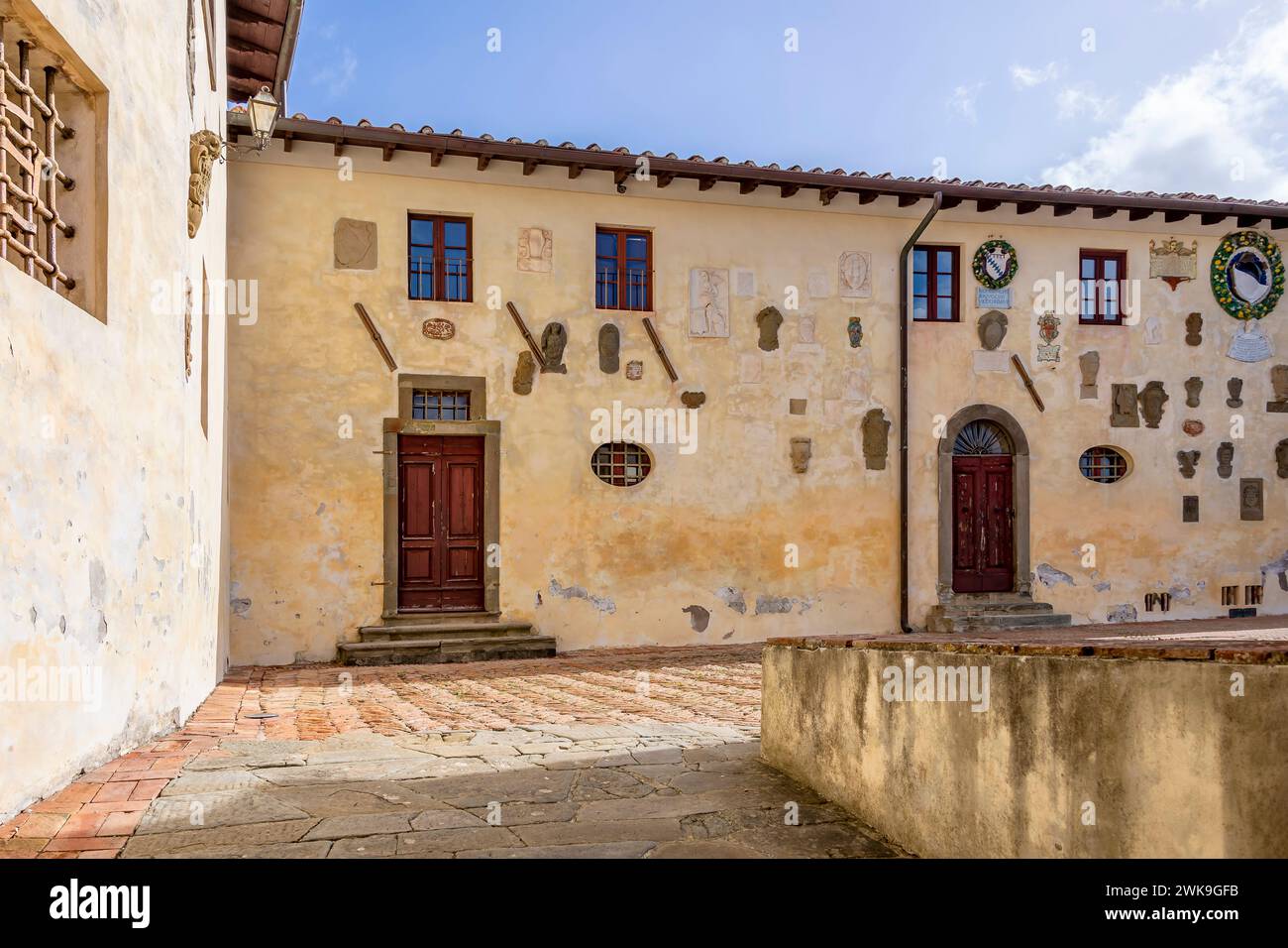 Ancient noble coats of arms adorn a wall in the castle area, Lari, Pisa ...