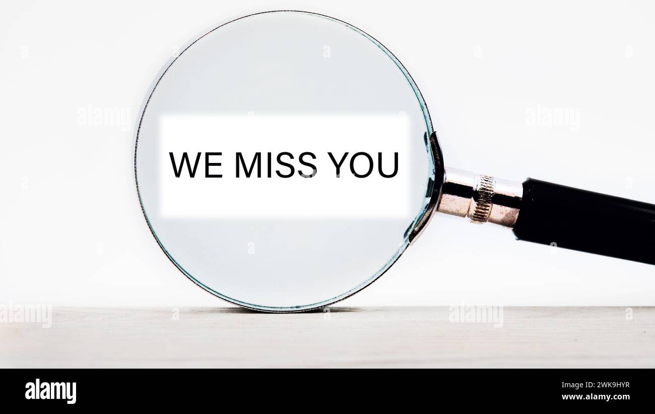 we miss you text written through a magnifying glass Stock Photo - Alamy
