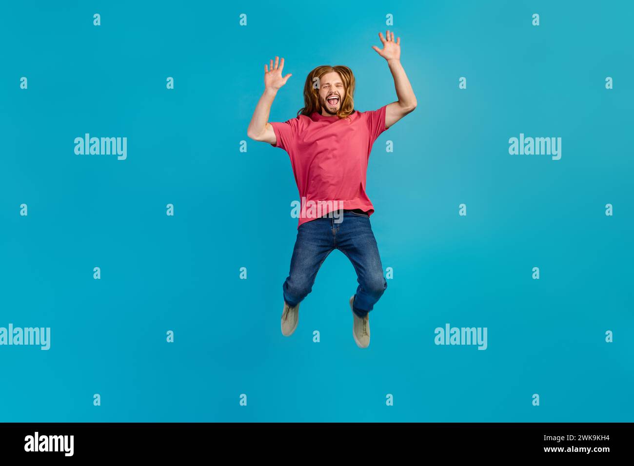 Full body portrait of astonished active person jumping raise arms empty ...