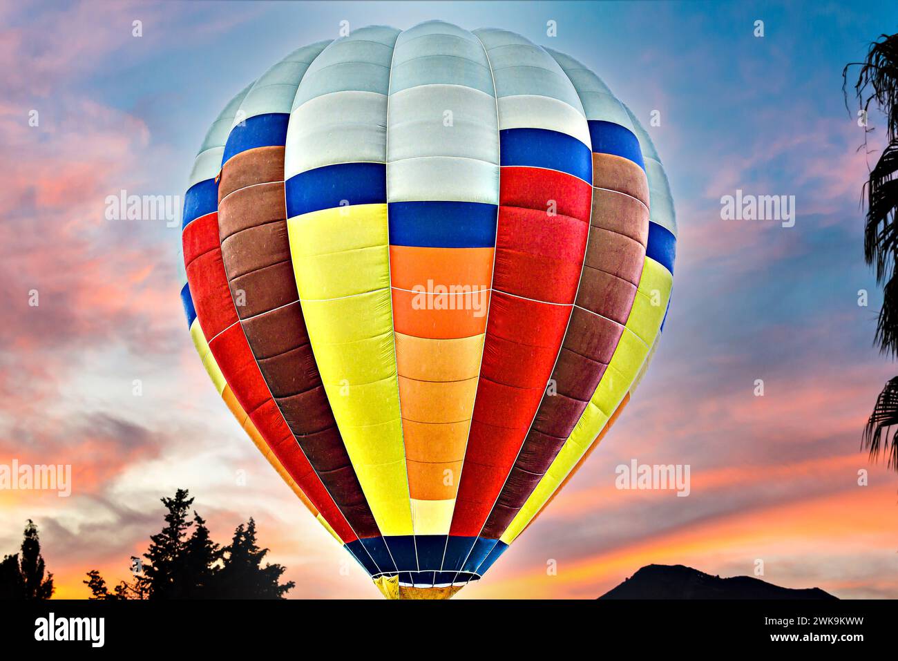 Colorful hot air balloon flying at sunset Stock Photo - Alamy
