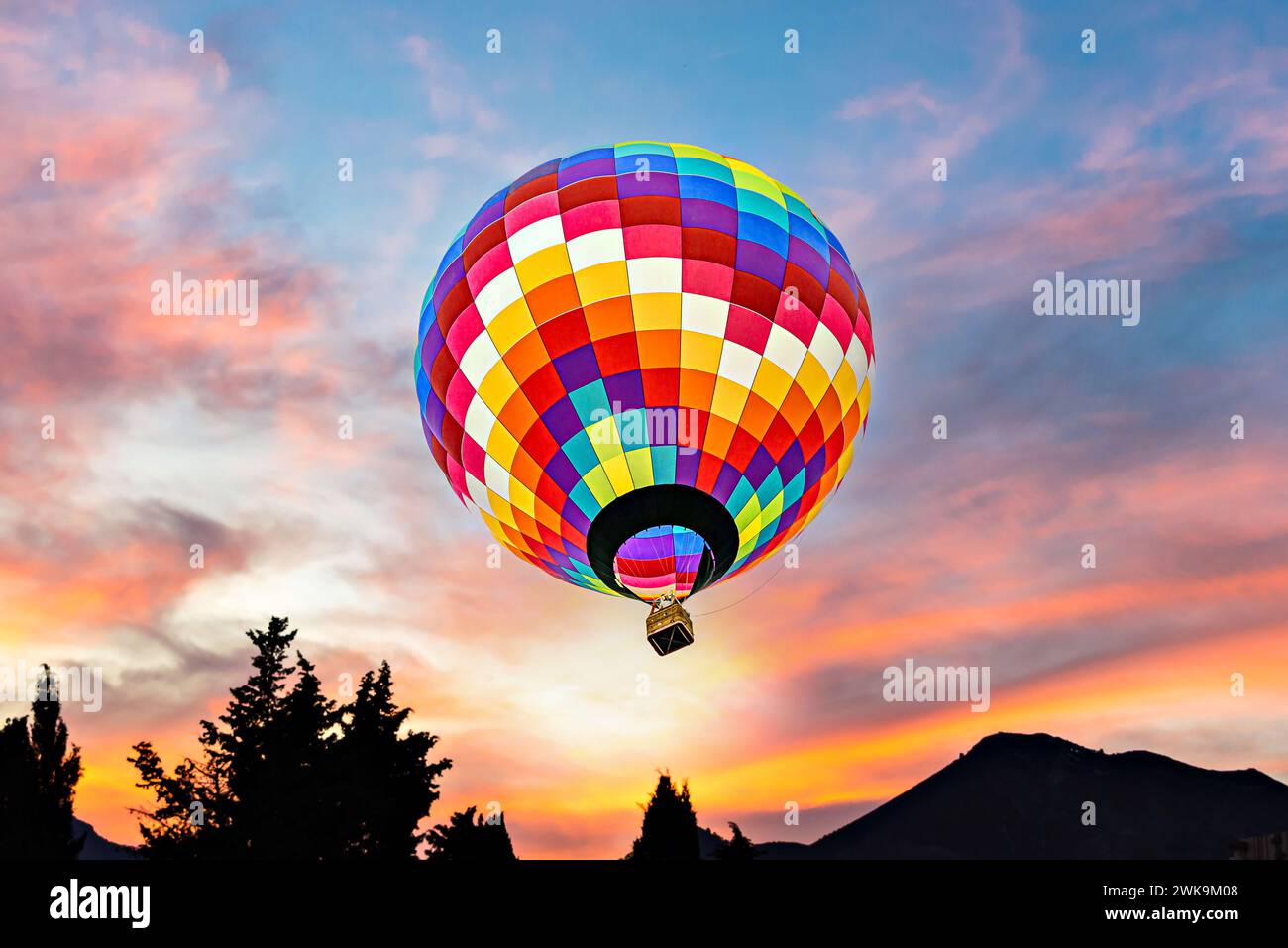 Colorful hot air balloon flying at sunset Stock Photo - Alamy