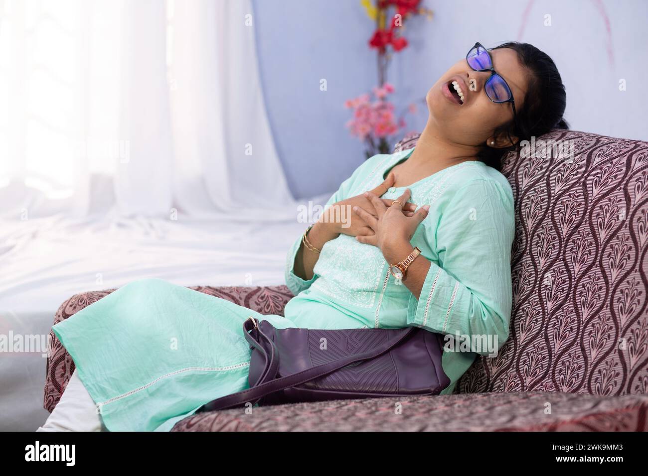 An Indian woman holding her chest for pain showing painful expression ...