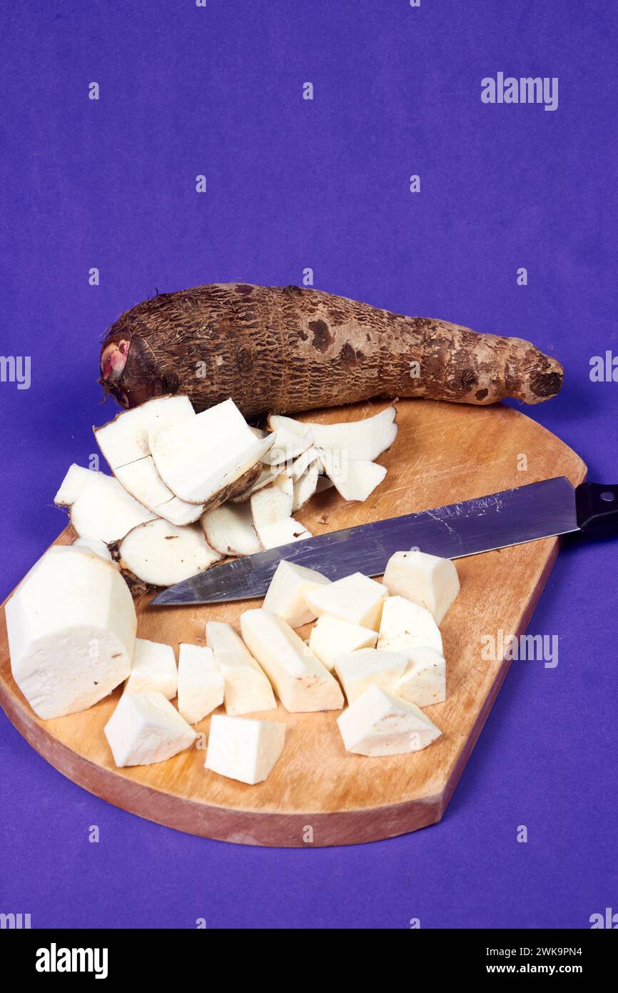closeup of taro root vegetable, eddo malanga, purple background Stock ...