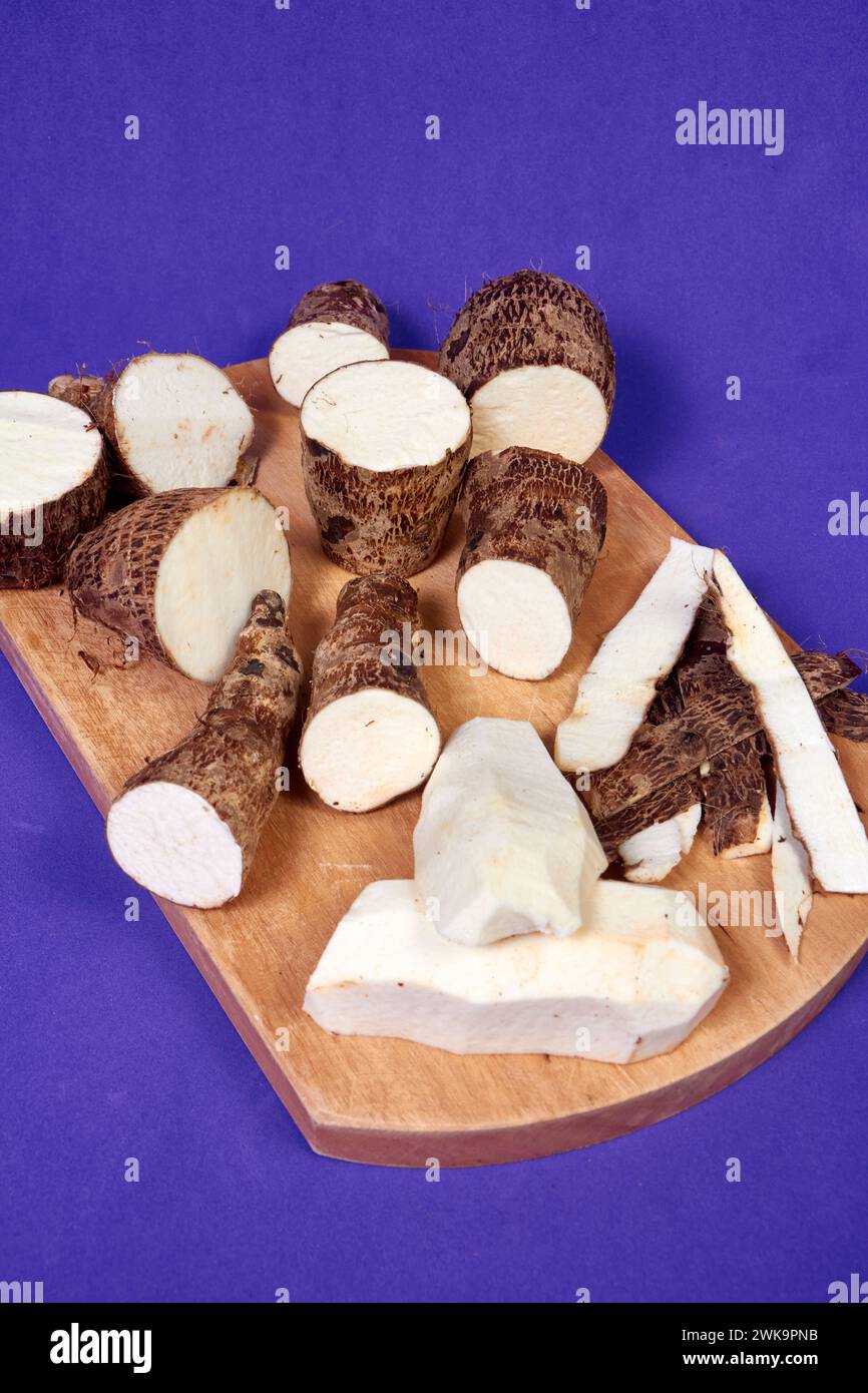 closeup of taro root vegetable, eddo malanga, purple background Stock ...
