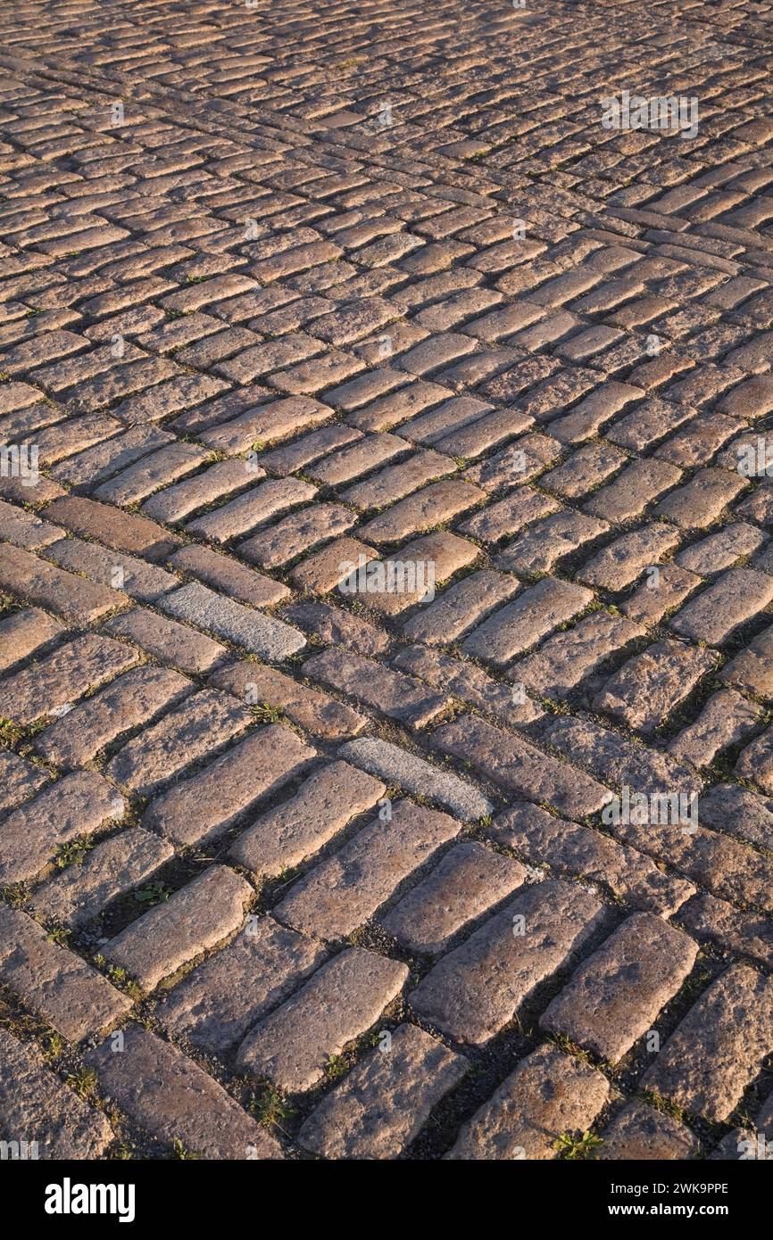 Close-up of rectangular tan and brown cobble style paving stones in ...
