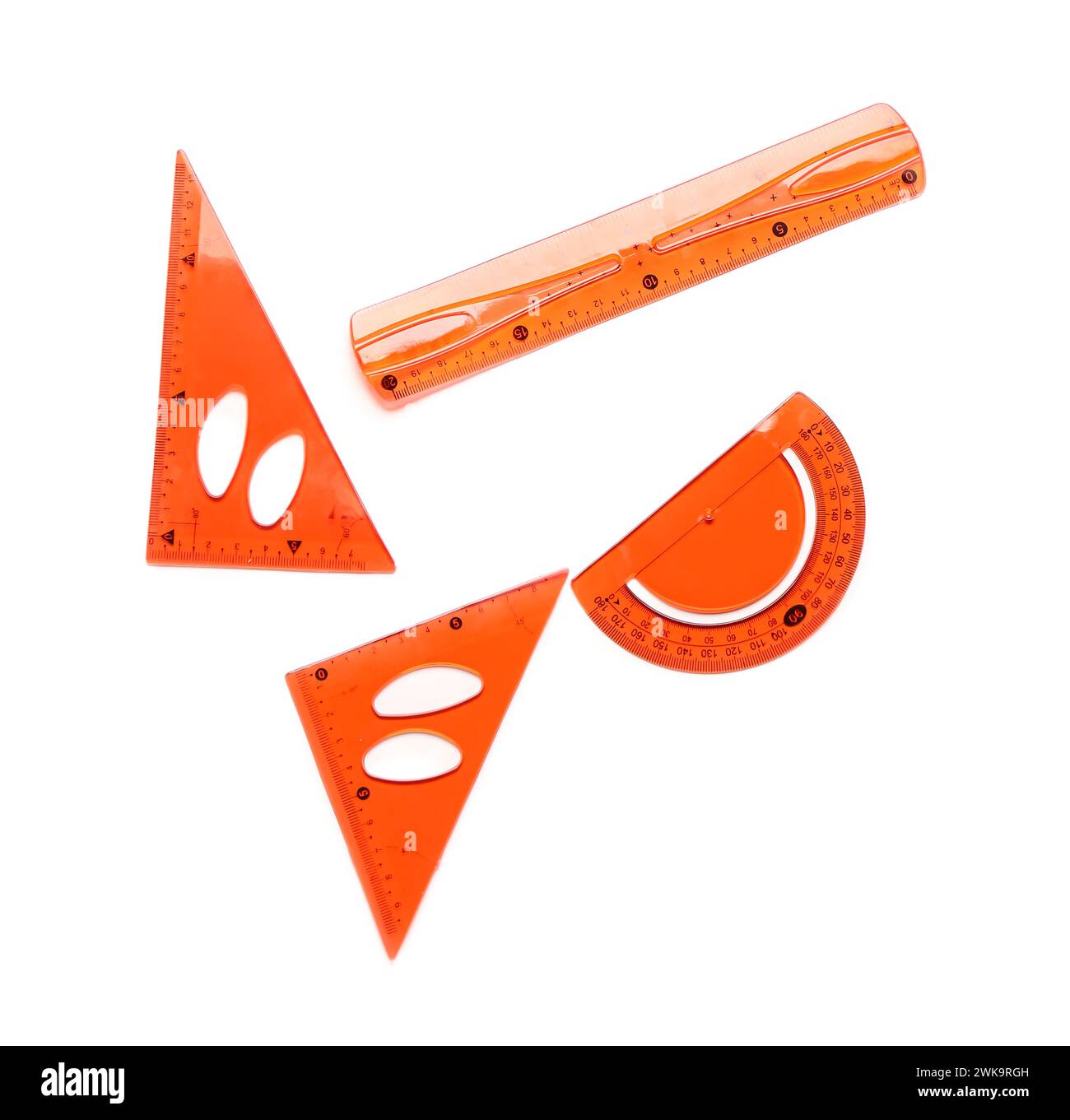 Orange straight and triangle plastic rulers with protractor on white ...