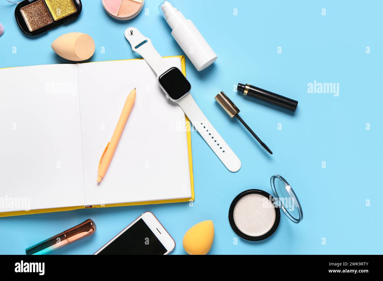 Composition with makeup cosmetics, modern mobile phone, smartwatch and ...