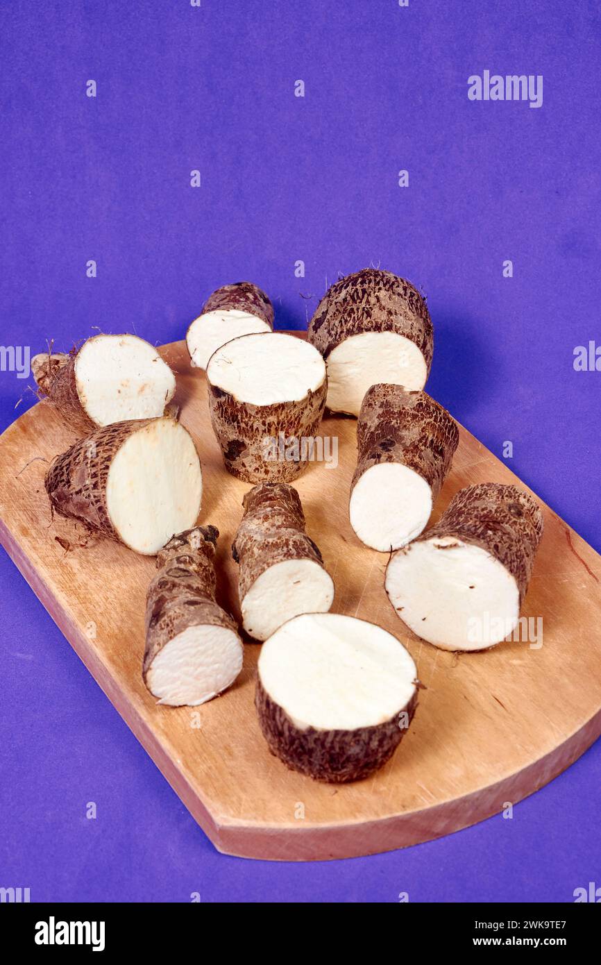 closeup of taro root vegetable, eddo malanga, purple background Stock ...
