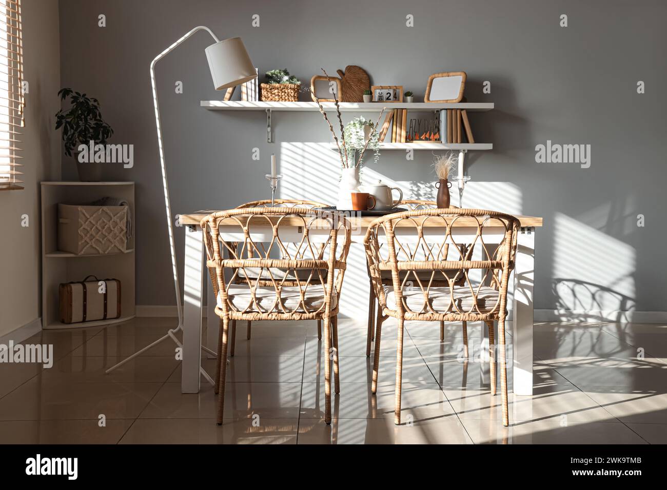 Interior of light room with dining table, lamp and shelves Stock Photo ...