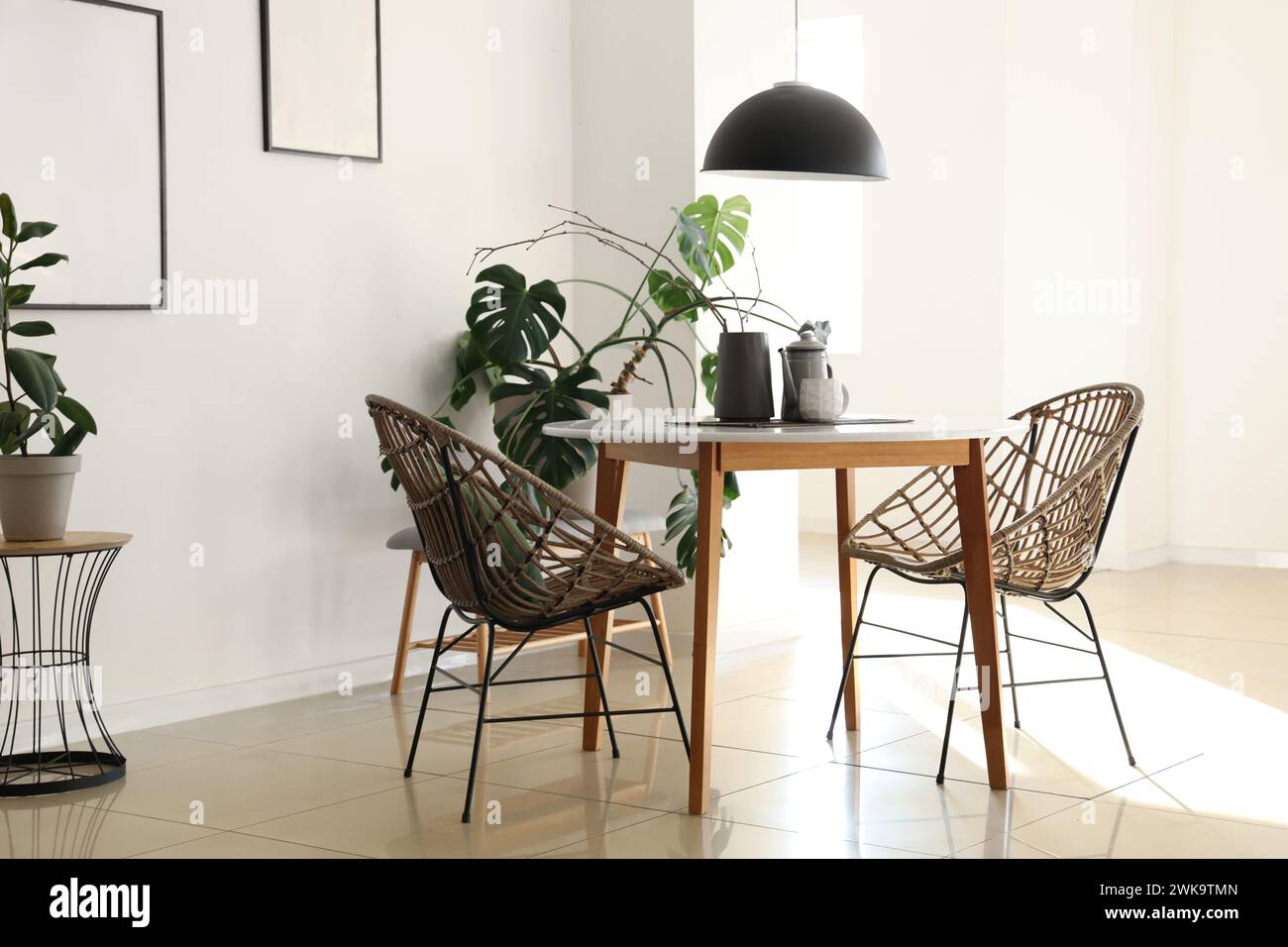 Interior of light room with dining table and lamp Stock Photo - Alamy