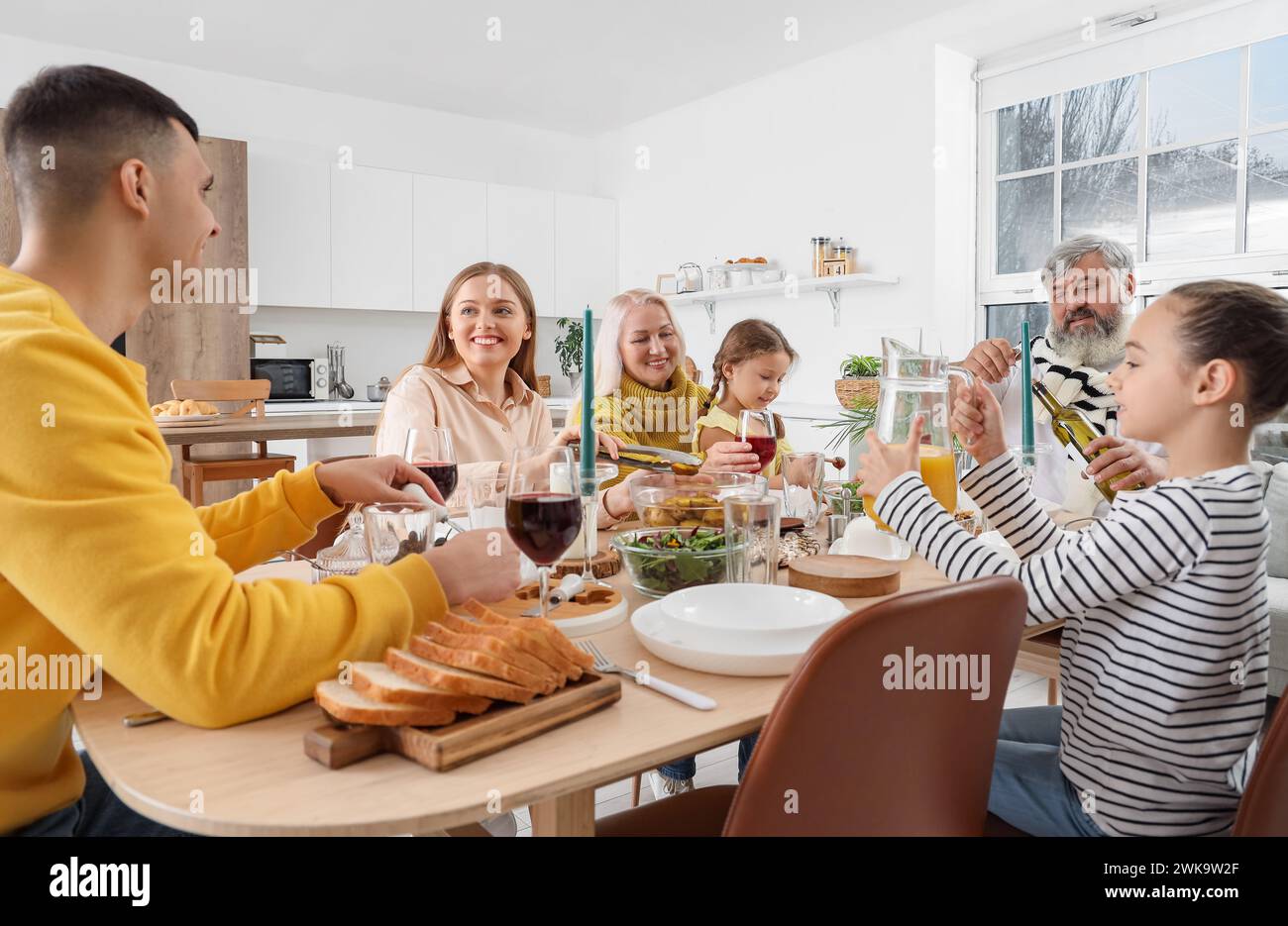 Big family having dinner in kitchen Stock Photo - Alamy