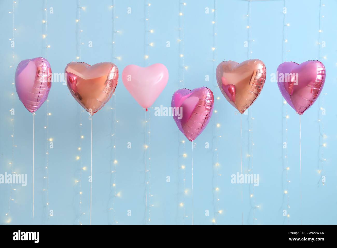Heart-shaped balloons with glowing lights on blue background. Valentine ...