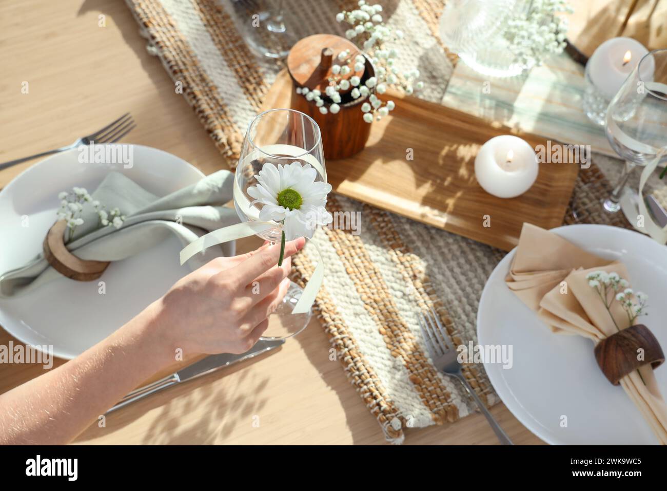 Female hand with stylish table setting for International Women's Day ...