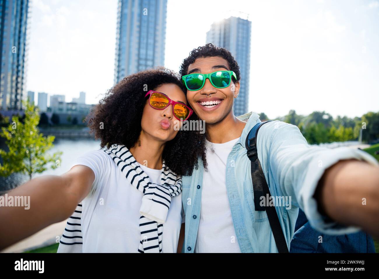 Selfie of young happy girlfriend with boyfriend pouty lips kiss and ...