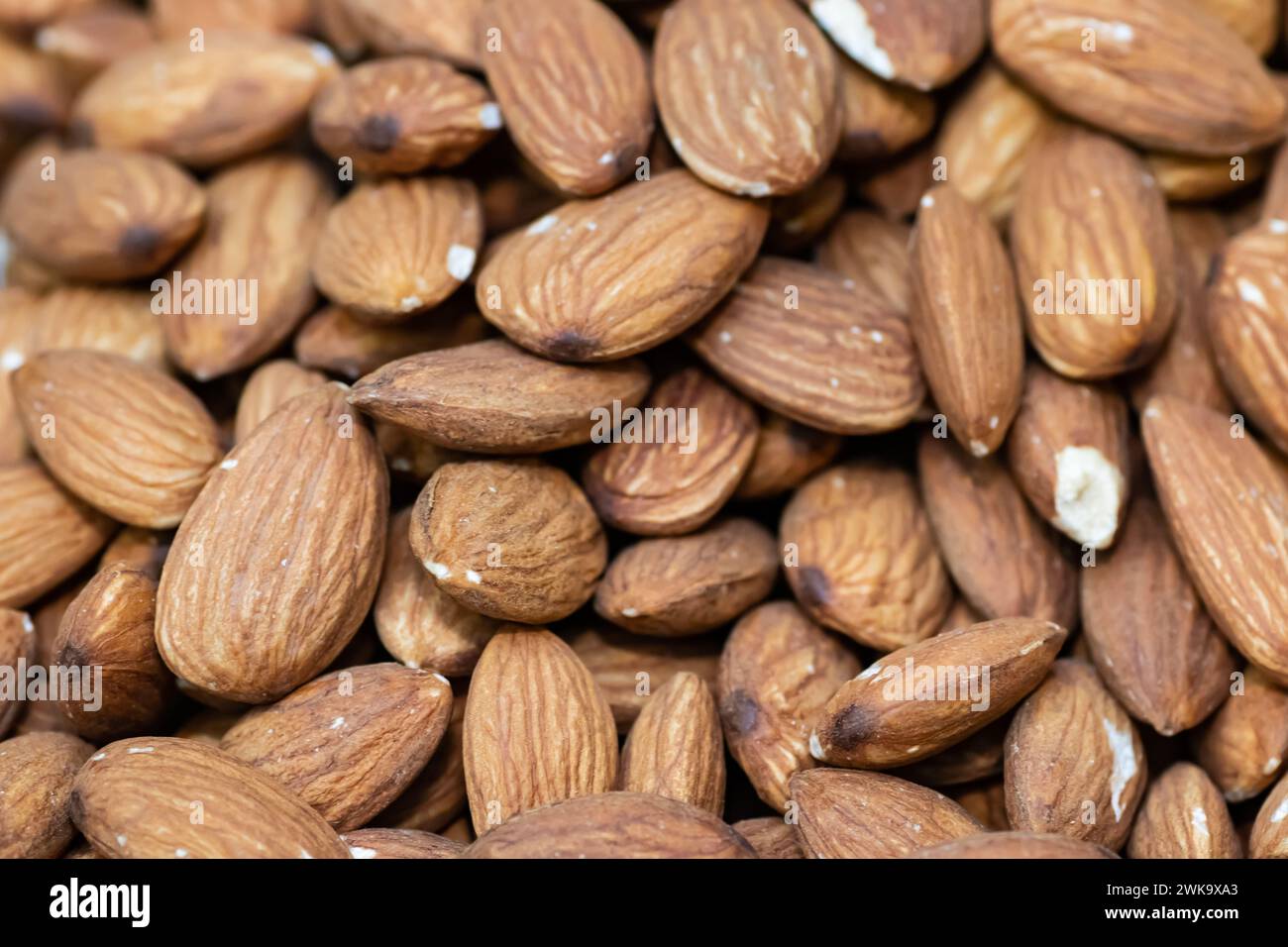 Dried and roasted almonds close up in street market healthy food shop ...