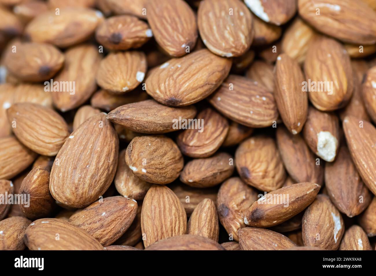 Dried and roasted almonds close up in street market healthy food shop ...