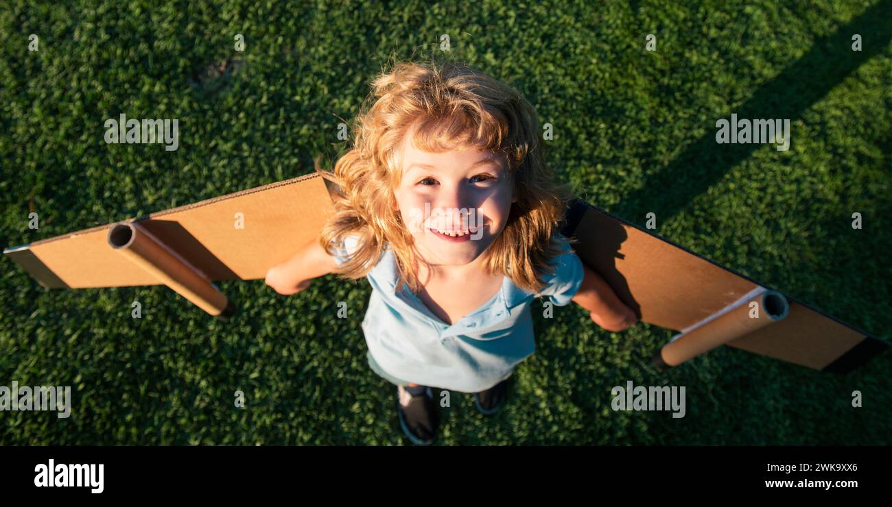 Child dreams of becoming a rocket pilot on green grass in park ...