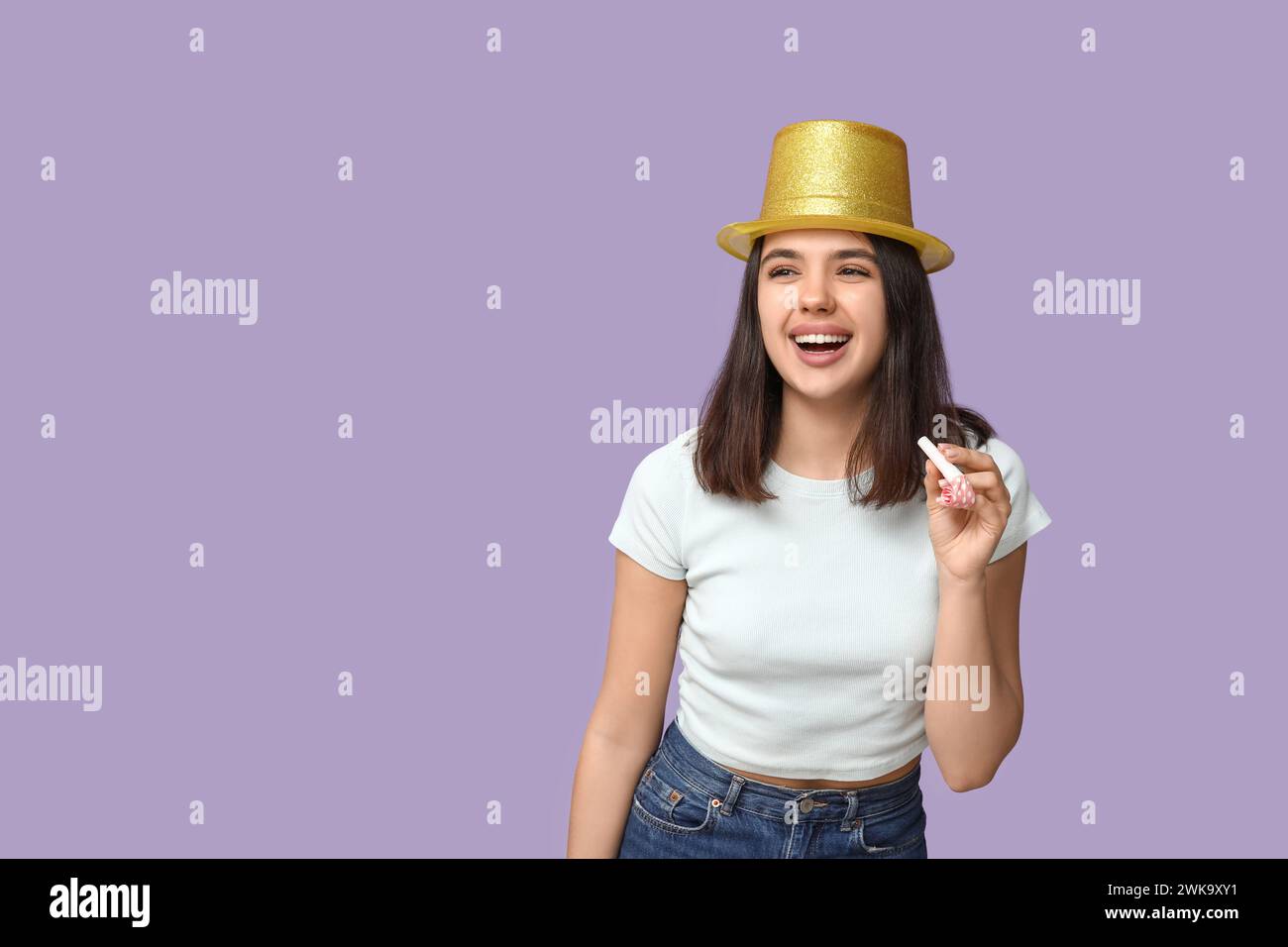 Beautiful young happy woman in funny disguise with whistle on purple ...