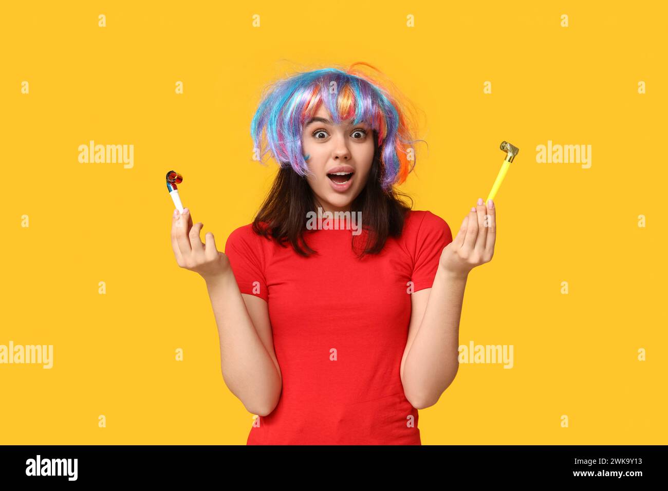 Beautiful young shocked woman in funny disguise with party whistles on ...