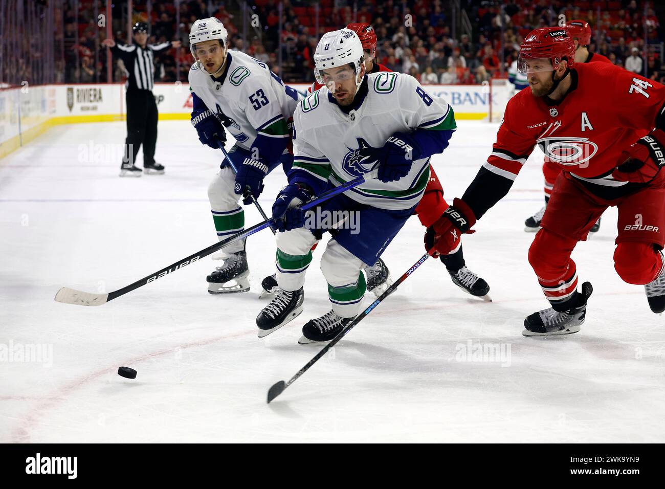 Vancouver Canucks' Conor Garland (8) battles for the puck with Carolina ...