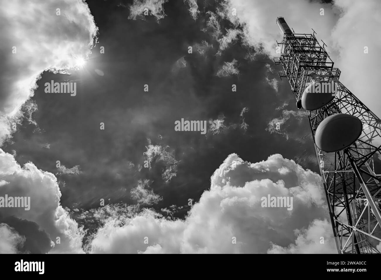 Soft backlit old mountain communication tower in the clouds. Converted ...