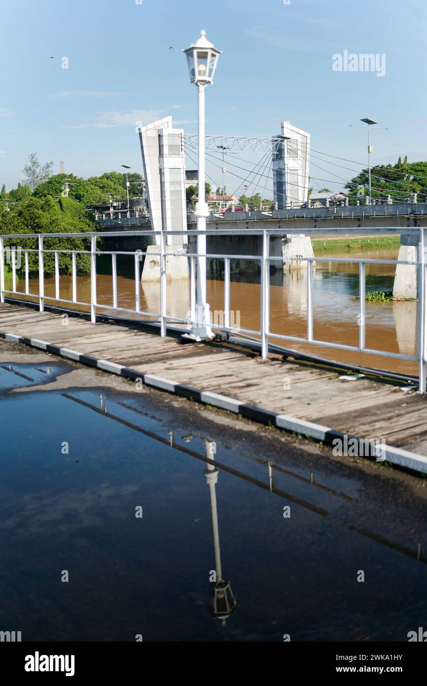 The reflection of old fashioned street lamp post in rain puddle on an ...