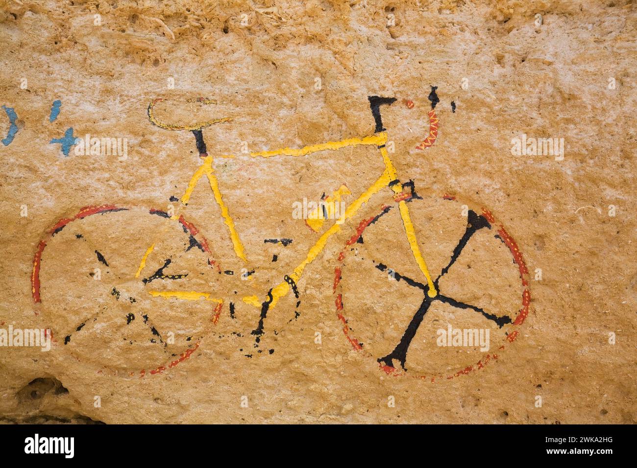 Carved painting of racing bicycle on prehistoric cave wall, Albufeira ...