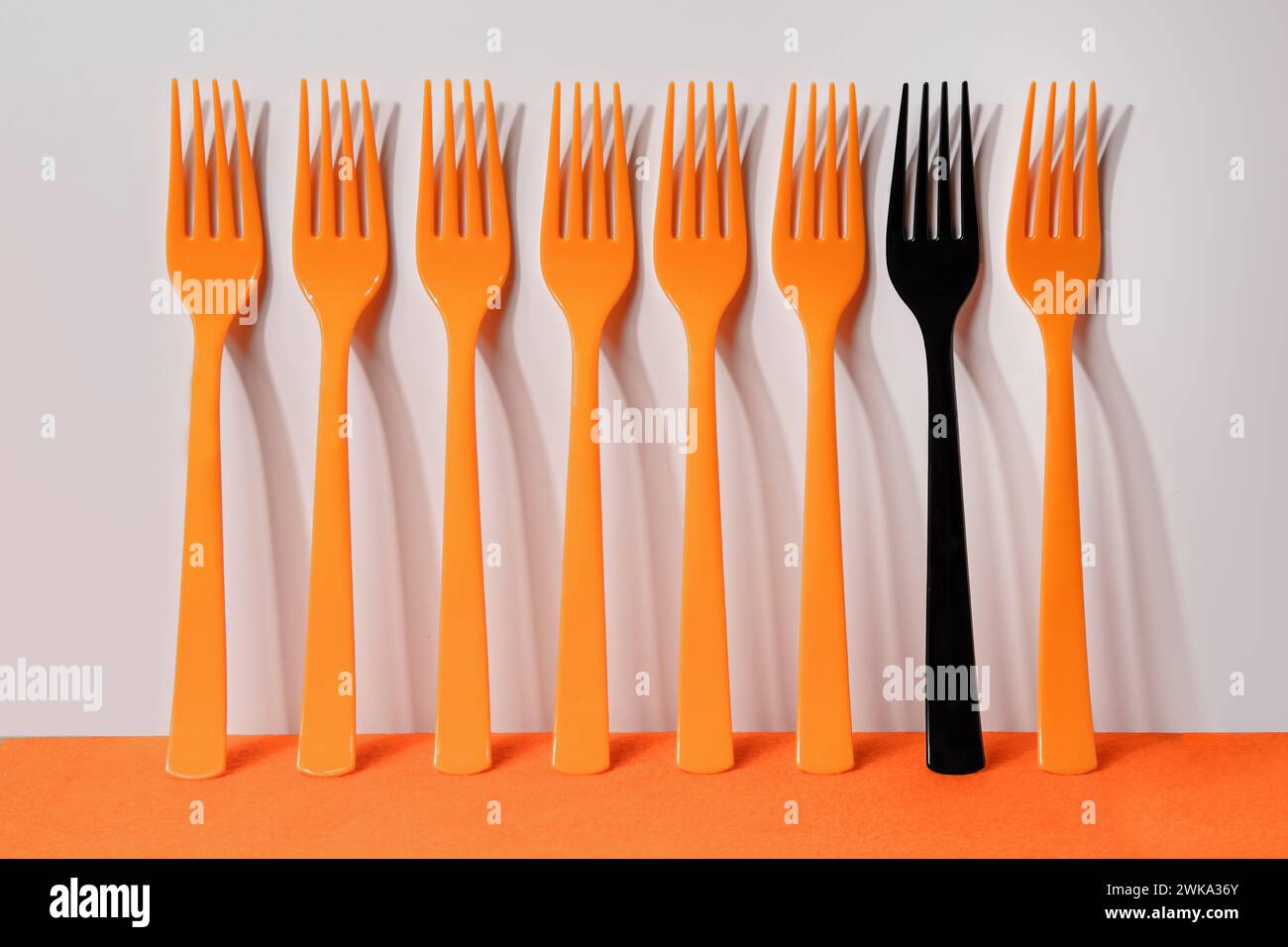 Five orange plastic forks on orange and white background Stock Photo ...