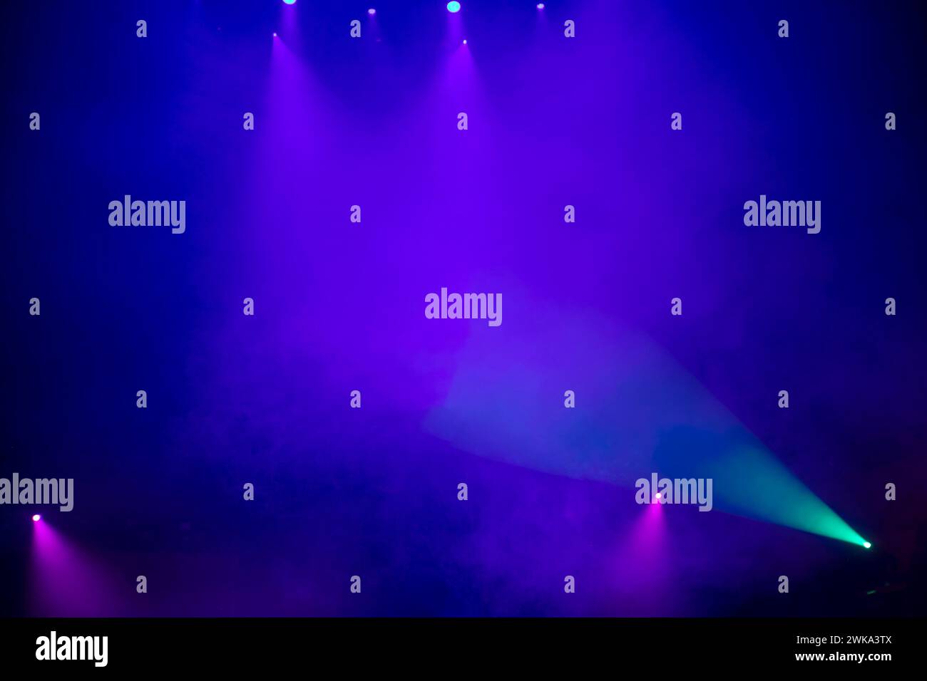 Bright festive multi-colored stage lighting with optical flare and rays ...