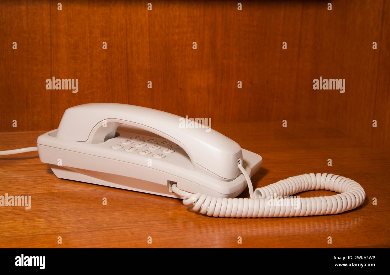 White retro touch-tone telephone on night table Stock Photo - Alamy