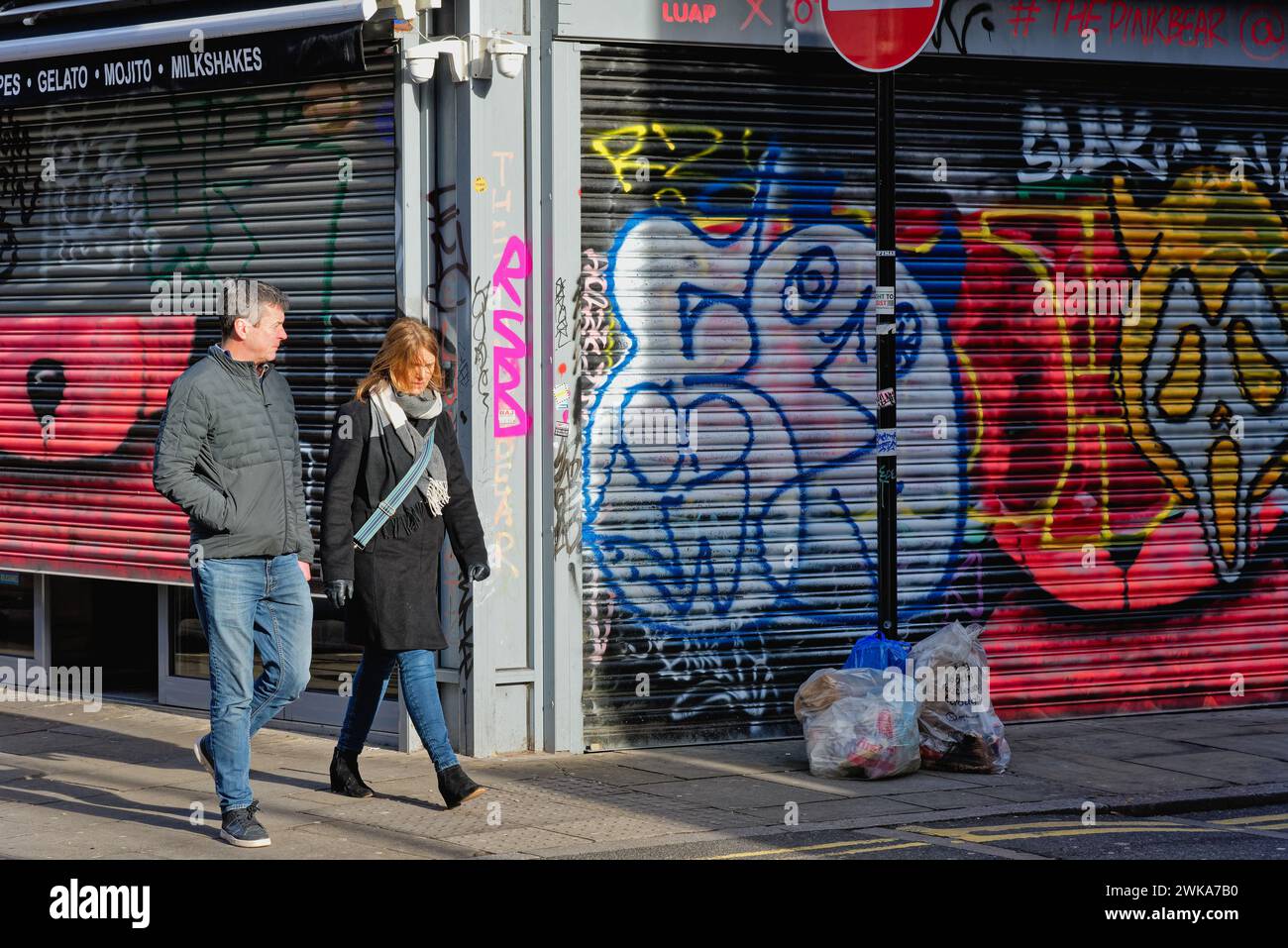 Colourful urban landscapes with graffiti on shuttering of shops, in ...