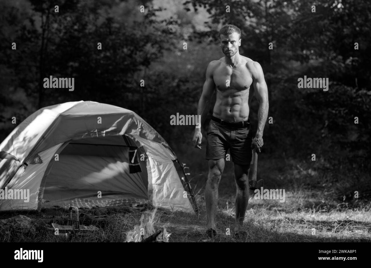 Handsome and muscular lumberjack man with an axe, camping. Man with axe ...