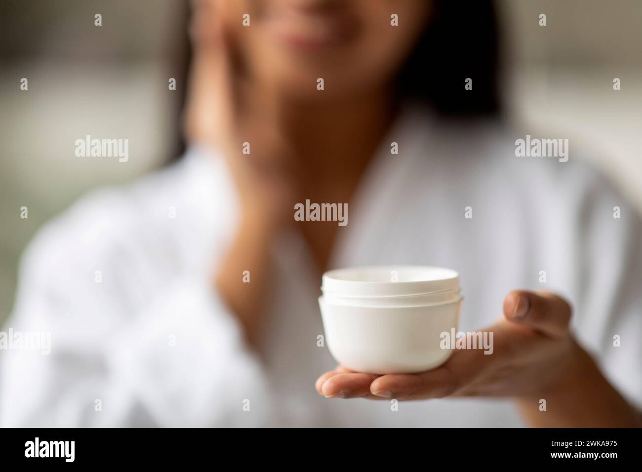 Hand with face cream, skin pampering concept Stock Photo - Alamy