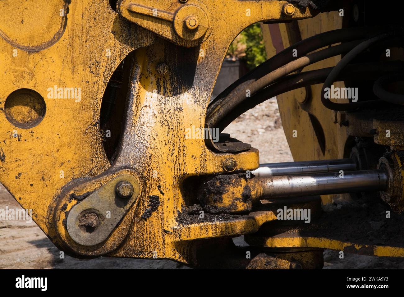 Grease and oil covered hydraulic system on yellow excavator Stock Photo ...
