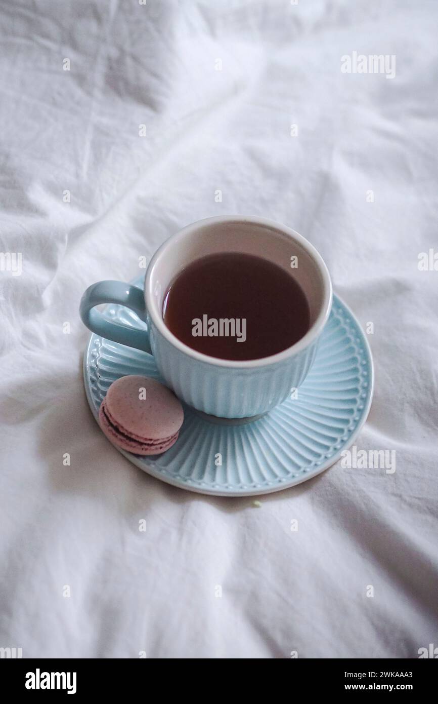 A tea cup and saucer rest on a bed Stock Photo - Alamy