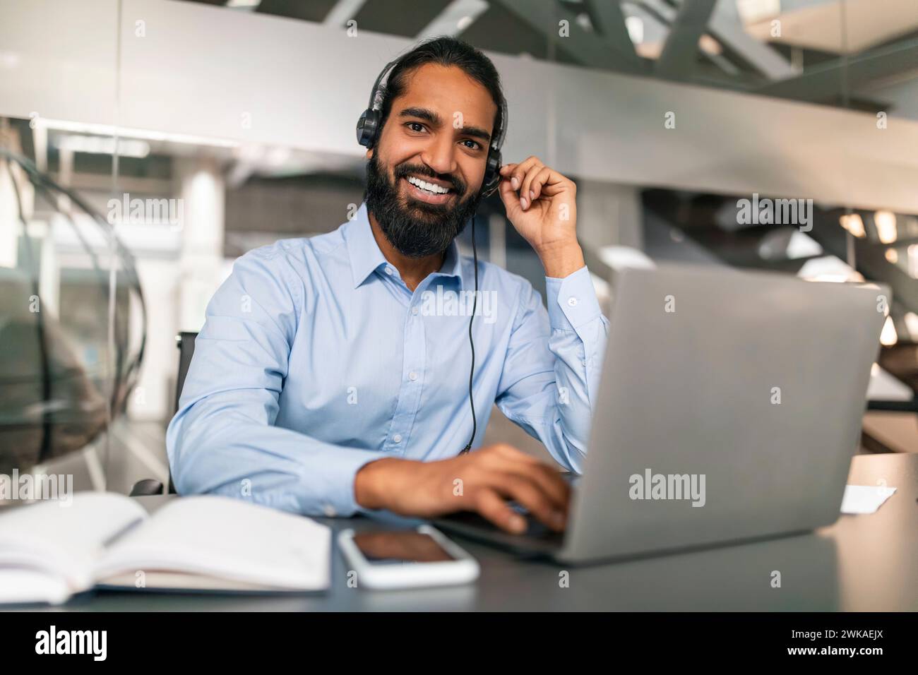 Young Indian Man Hotline Manager In Headset Using Computer Stock Photo ...
