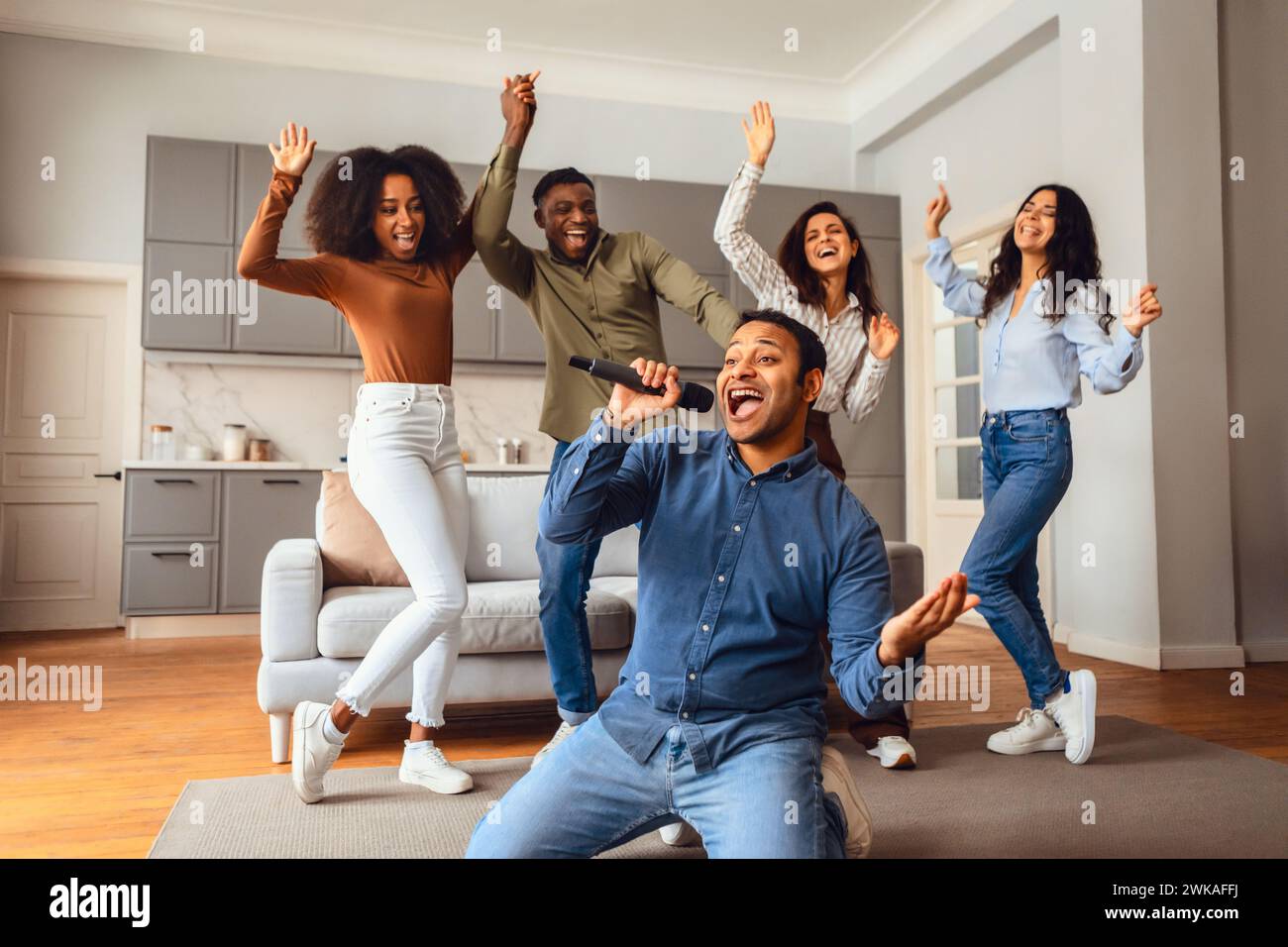 Indian guy sings during karaoke gathering with diverse millennials ...