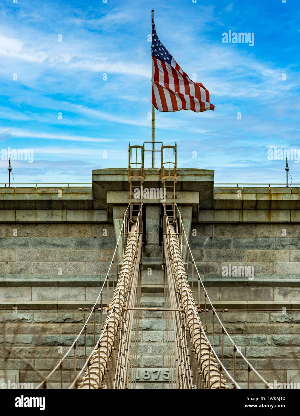 Vertical photo of a sunny day of the Brooklyn Suspension Bridge linking ...