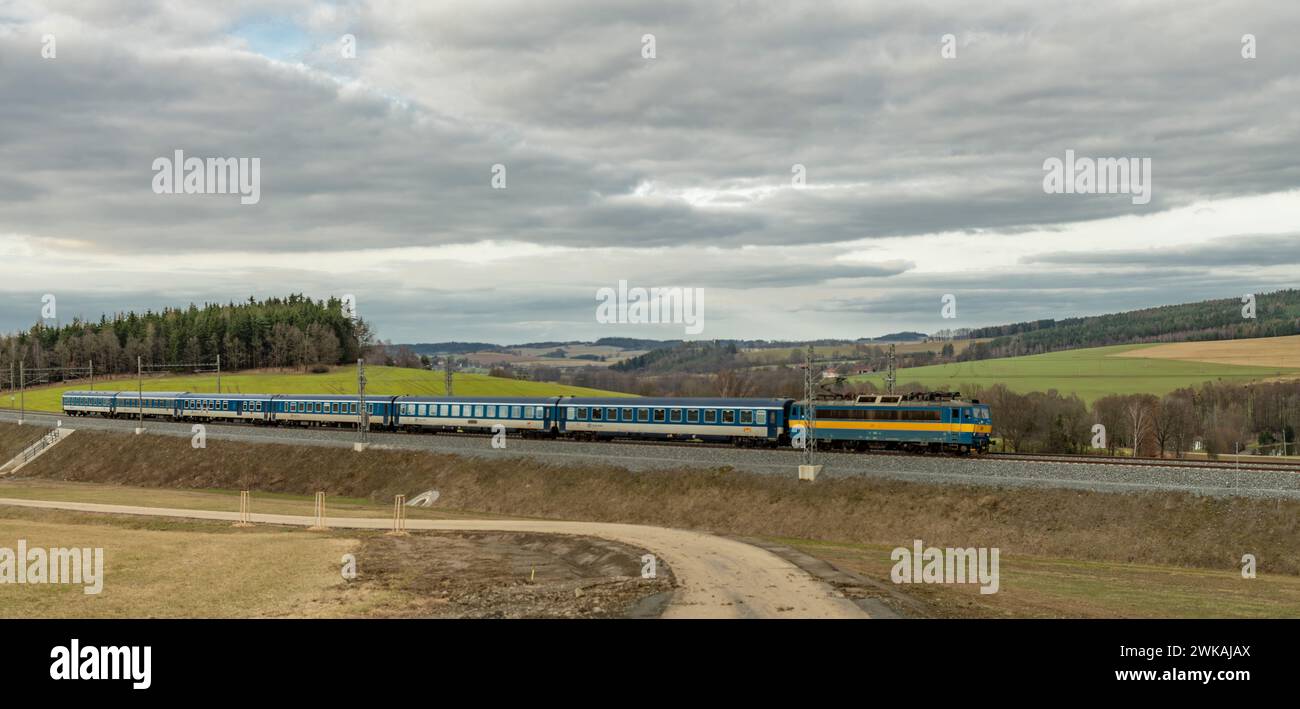 Passenger trains near high speed tunnel in railway stop in Jesetice CZ ...