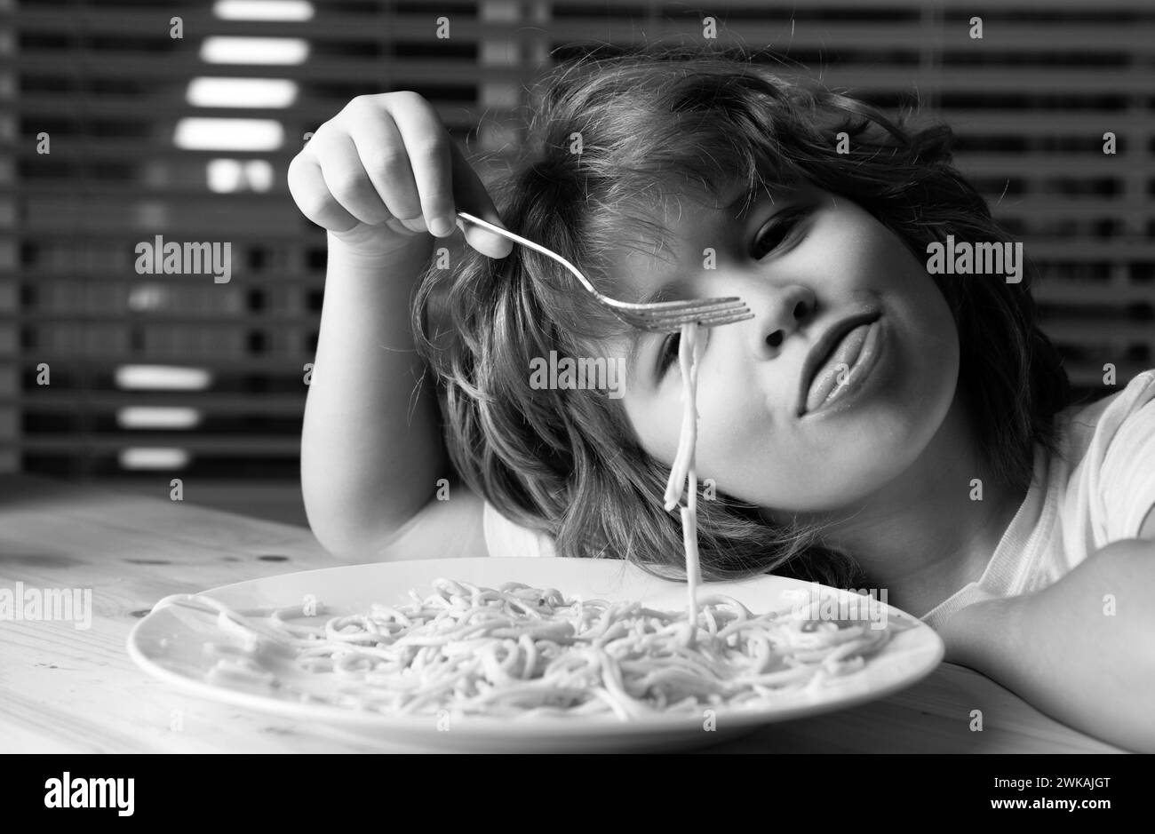 Portrait of a cute child boy. Close up caucasian kid eating pasta ...