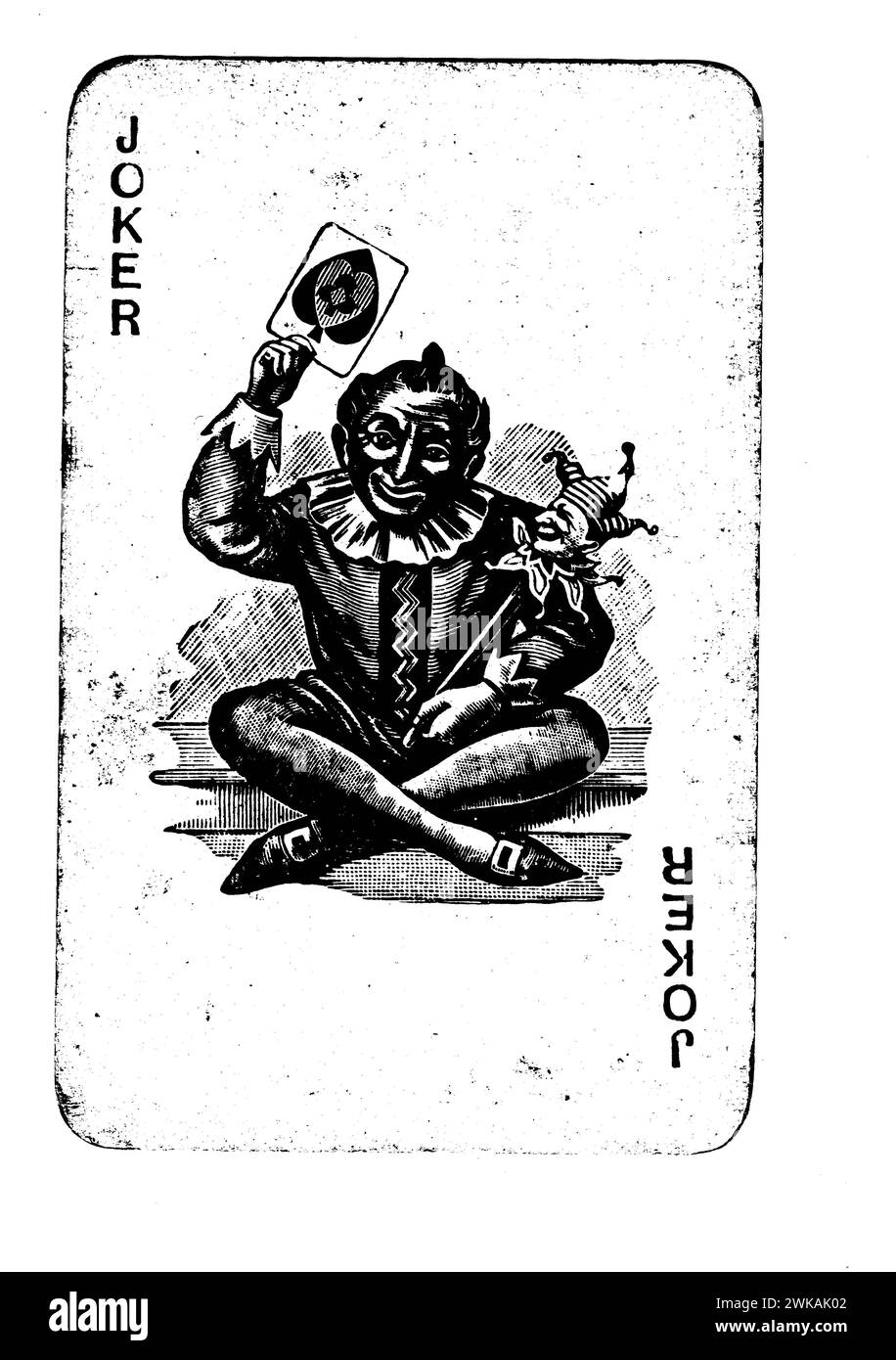 A vintage joker playing card in black and white isolated on a white ...