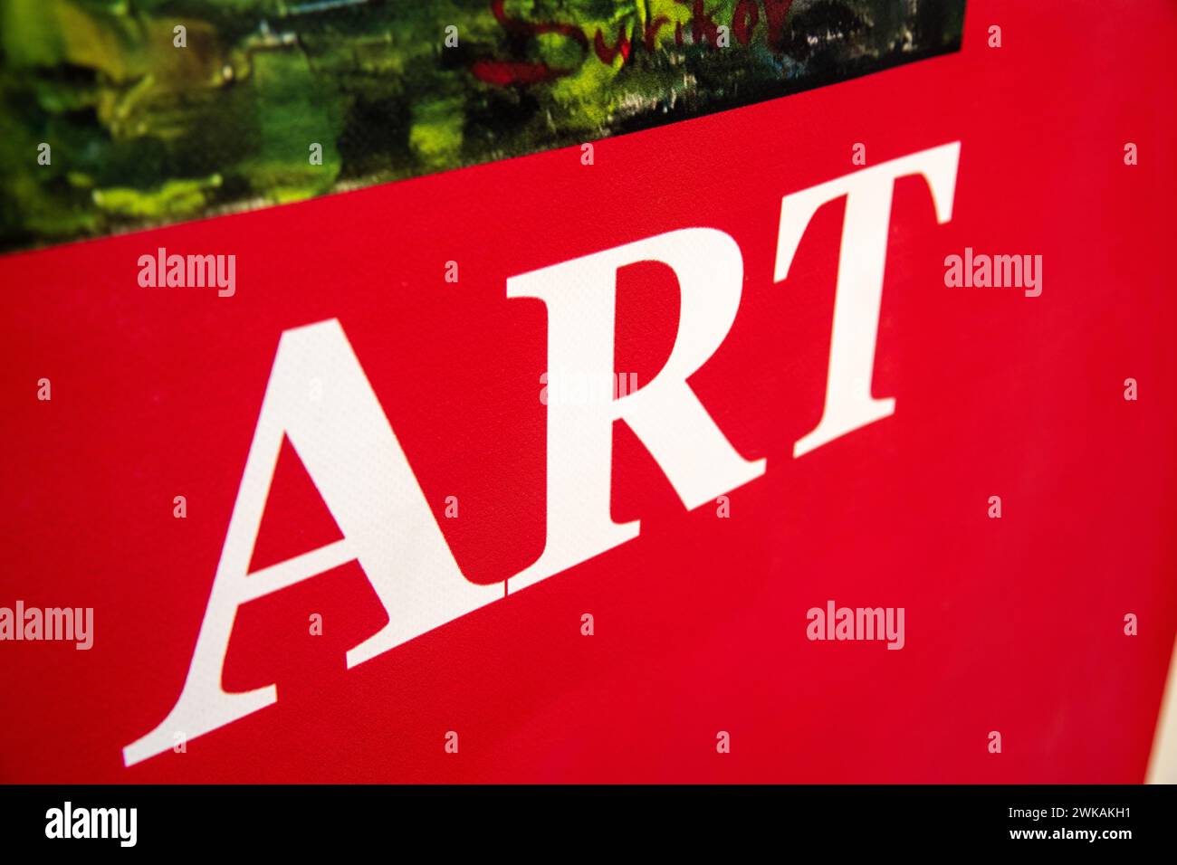 A red sign with white letters that spell the word Art. The sign is ...