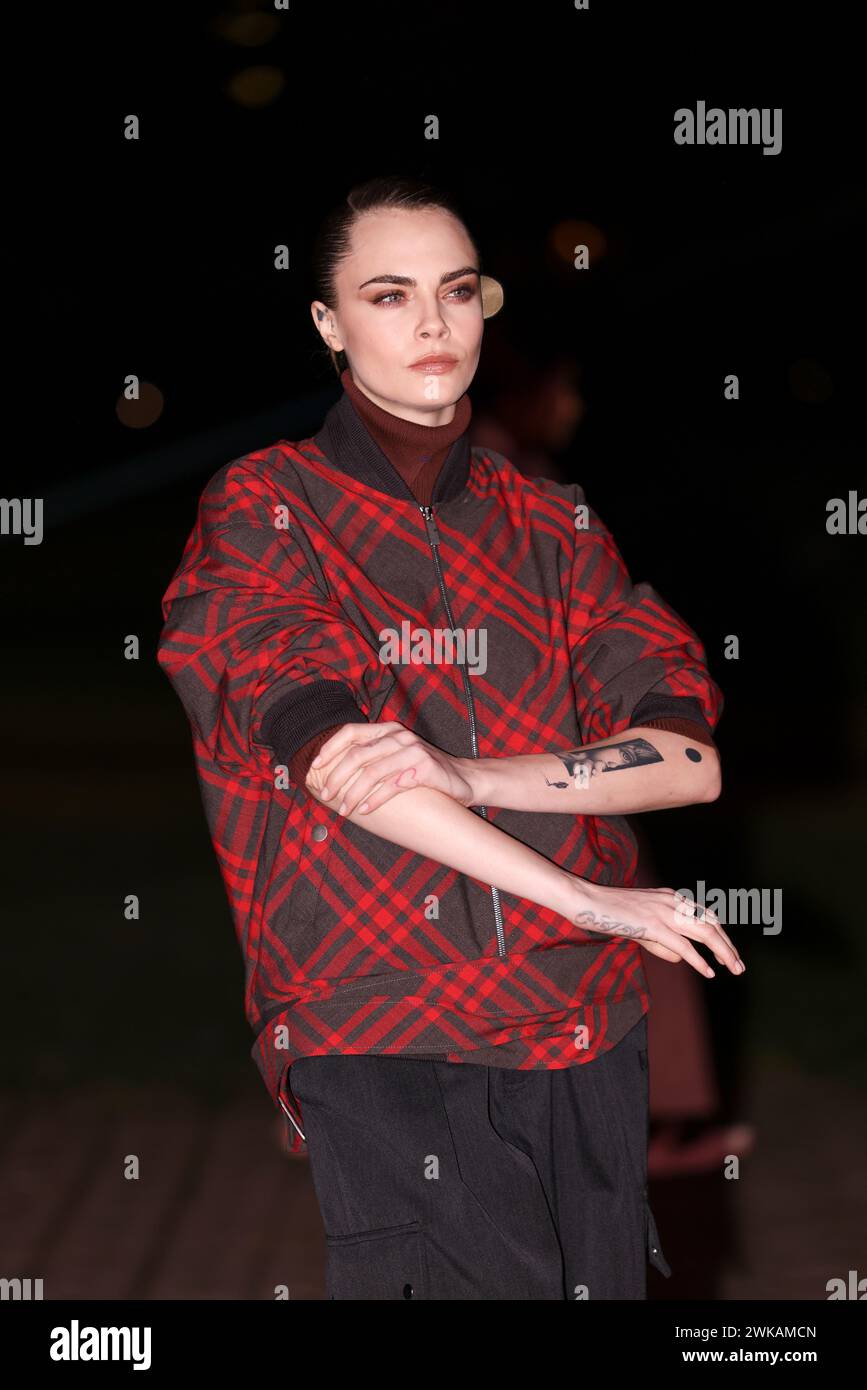 Cara Delevingne poses for photographers upon arrival at the Burberry ...