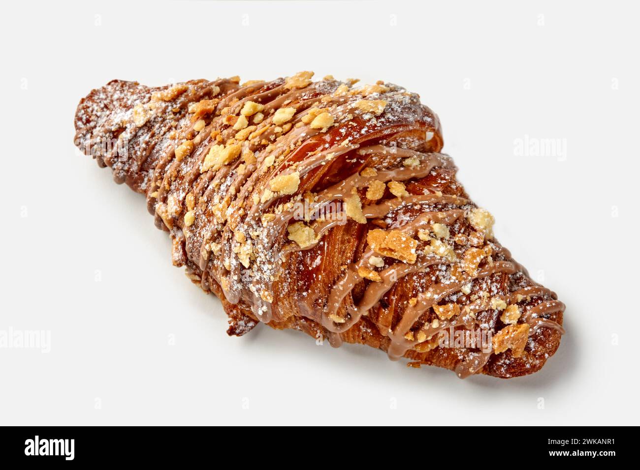 Golden croissant with chocolate icing and caramelized crumbles Stock ...