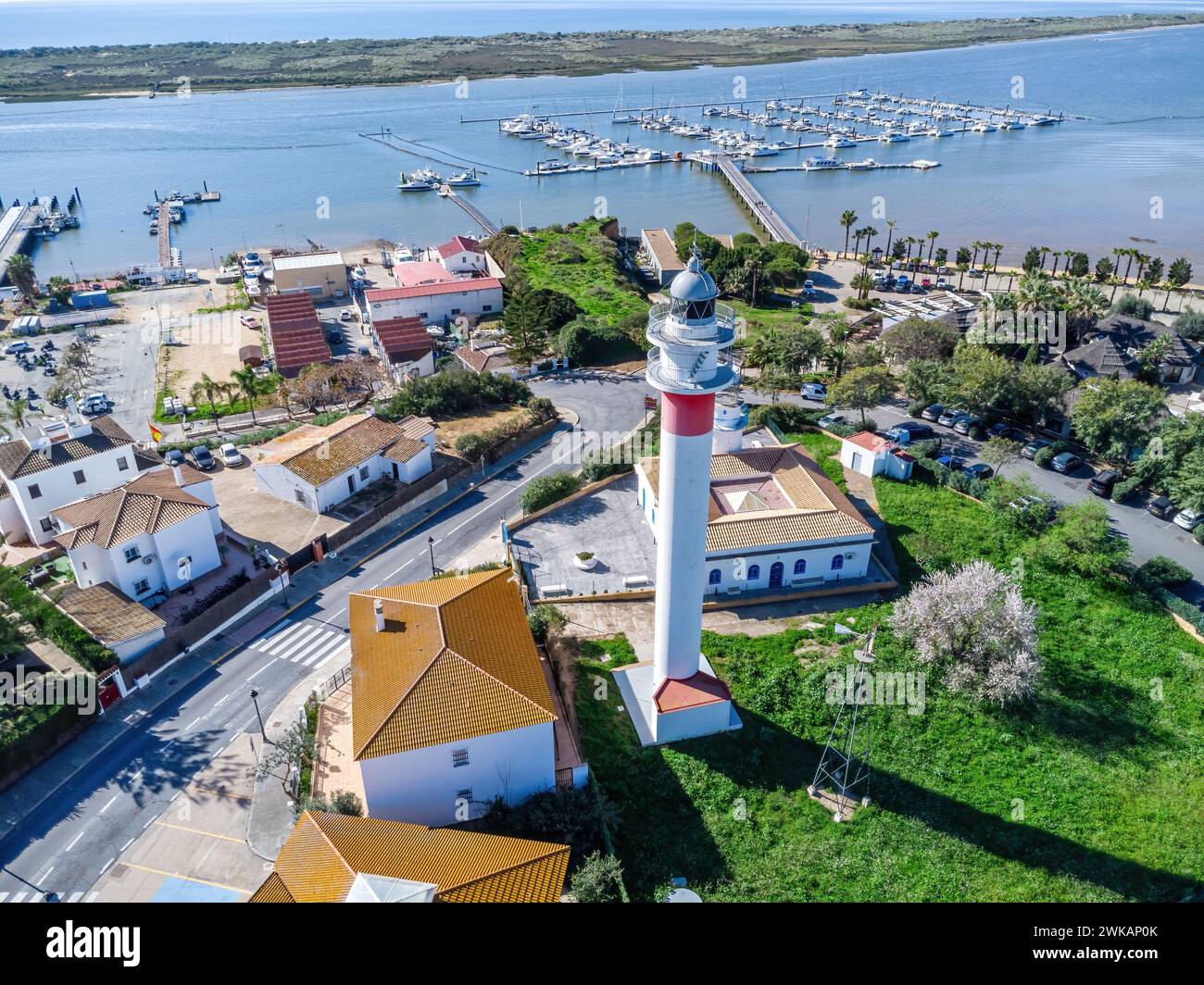 Aerial view of Lighthouse tower in the beach village El Rompido, in the ...