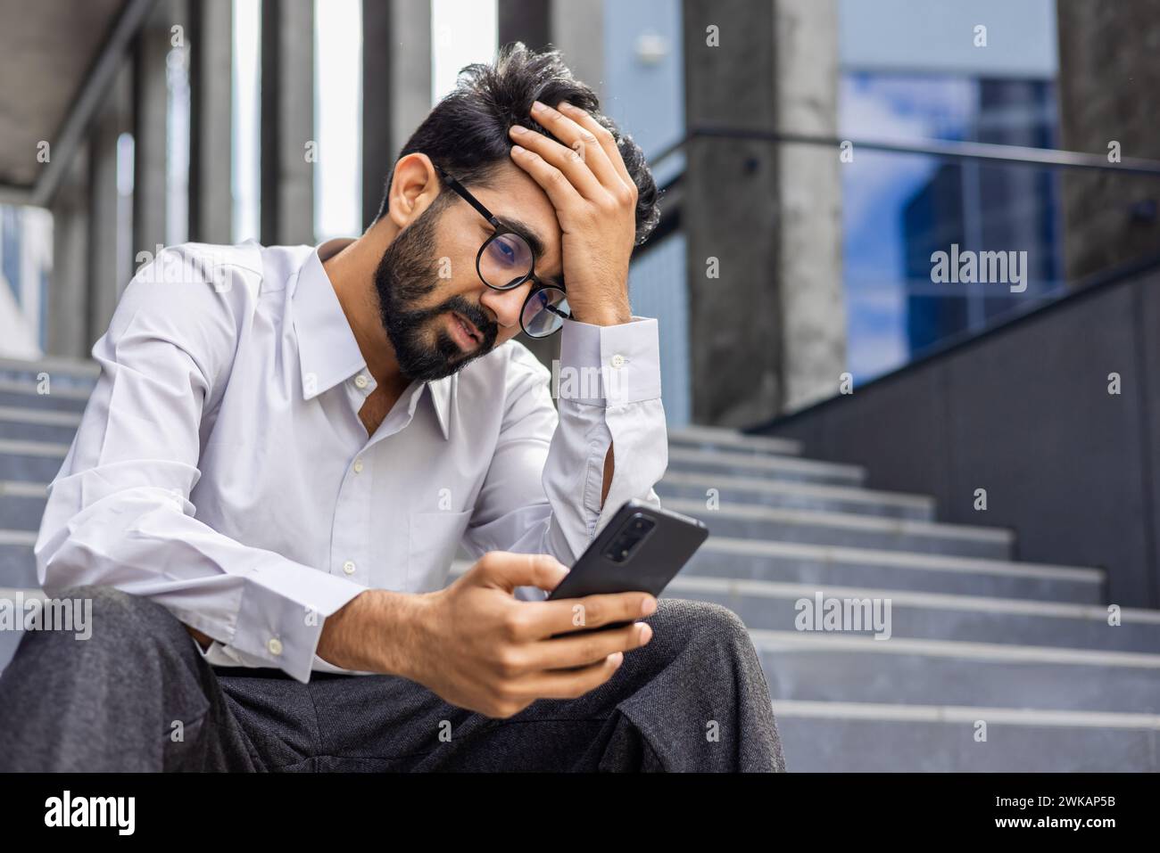Young man depressed, sad dissatisfied and unhappy outside office ...