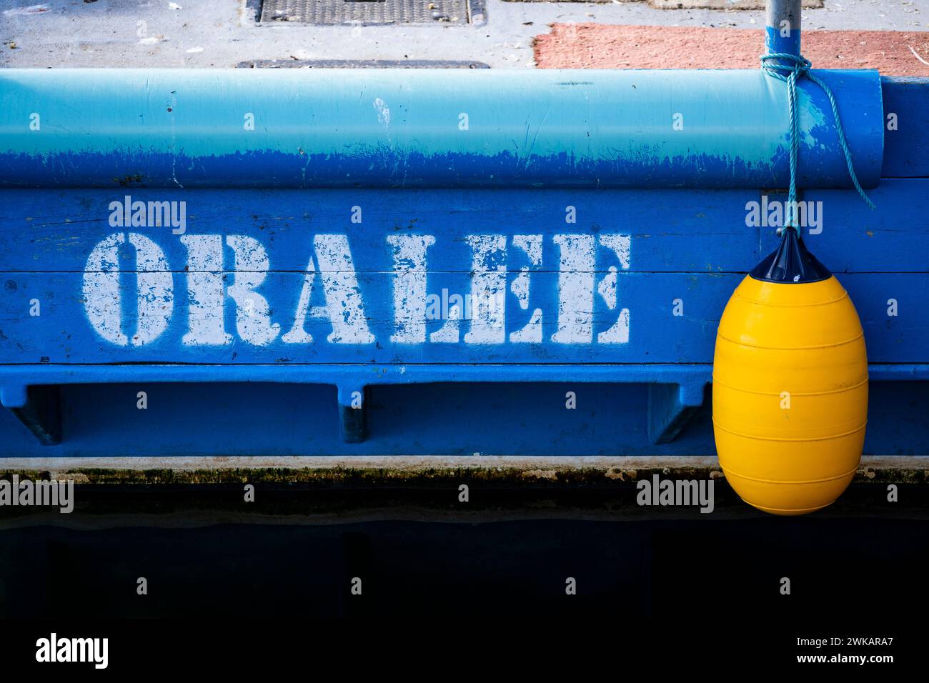 Yellow buoy hanging from the transom/stern of a small fishing boat ...
