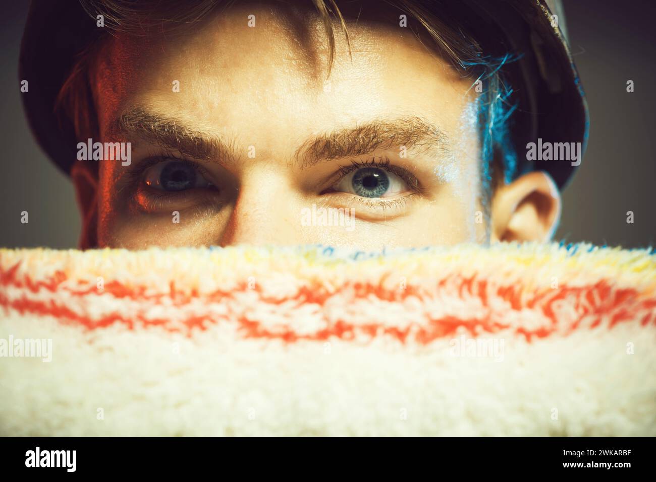 Closeup portrait male painter or decorator with paint roller. Interior ...